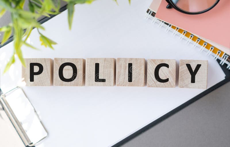 Policy Word Written on Wood Block. Policy Text on Cement Table for Your ...