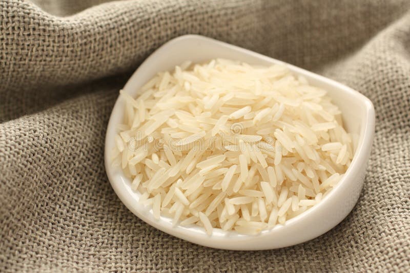 Polished Long Rice Grains in White Ceramic Bowl Stock Photo - Image of ...