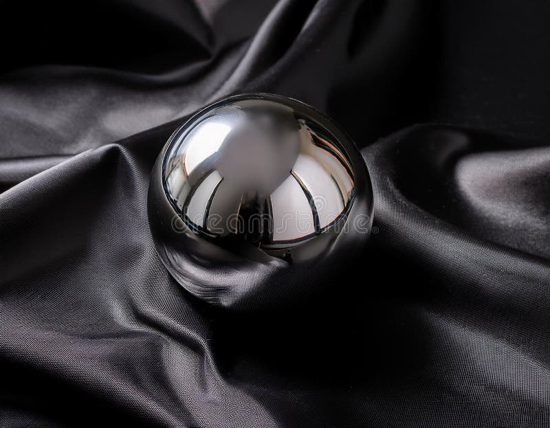 Polished Silver Sphere on Black Fabric Stock Image - Image of ...
