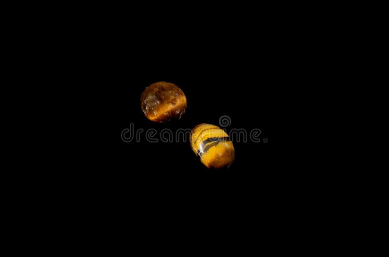 Polished Tiger S Eye on Black Background Stock Photo - Image of ...