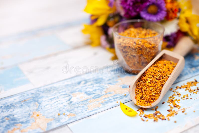 Pollen in Wooden Scoop on the Table with Plastic Glass and Flower Stock ...
