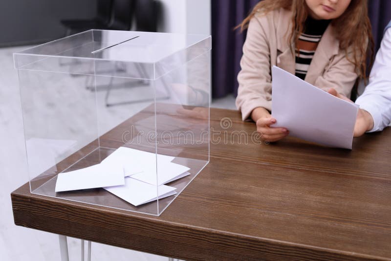 Polling Station Workers at Table Stock Photo - Image of document ...
