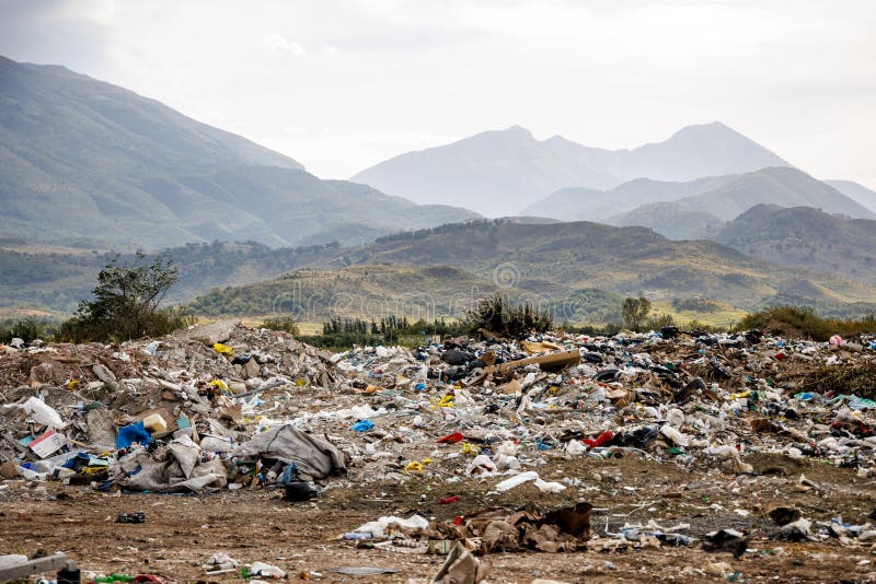 Polluted Landscape with Waste in Front of a Mountain Background - Shot ...