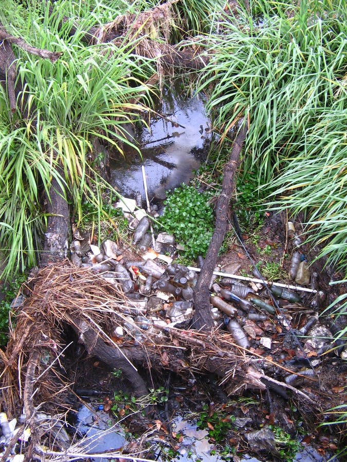 Pollution in a Creek with Trash and Plastic Bottles. Stock Image ...