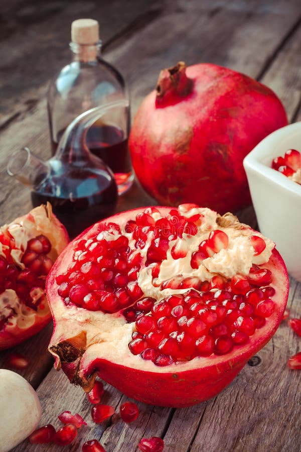 Pomegranate and Bottles of Essence or Tincture on Table Stock Photo ...
