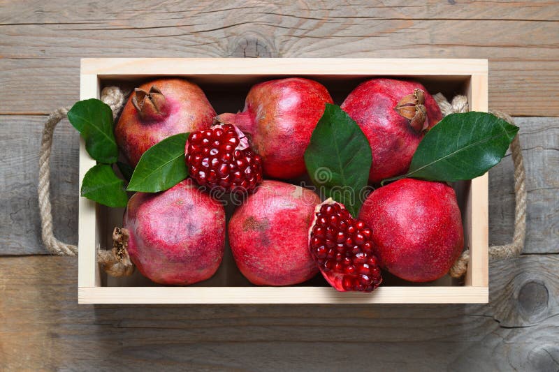 Red pomegranates in a box stock photo. Image of sample - 17181954