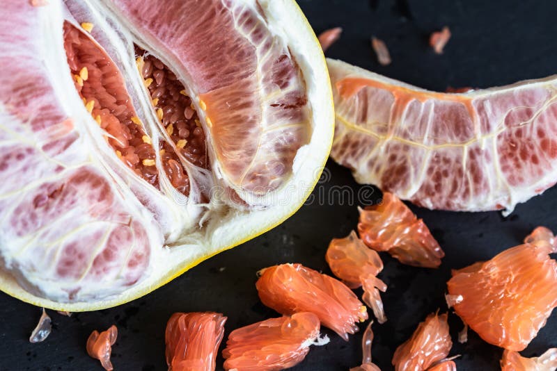 Pomelo with Red Pulp in Front of Dark Background Stock Photo - Image of ...