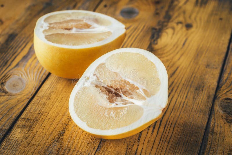 Pomelo on the wooden table stock photo. Image of pommelo - 137857926
