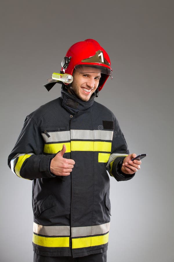 Pompiere Con Lo Smart Phone Che Mostra Pollice Su. Fotografia Stock ...