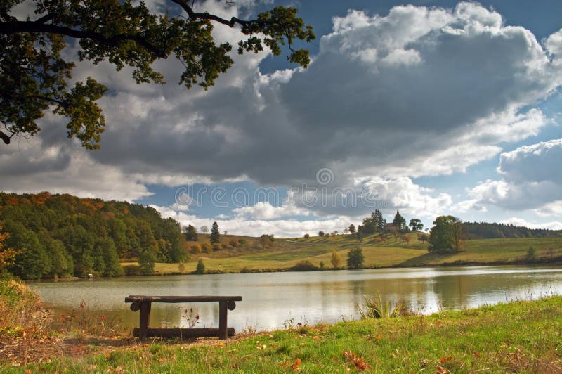 Pond and bench stock photo. Image of spring, lake, cloud - 1582292