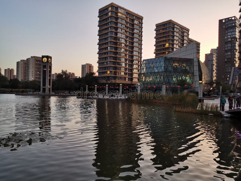 Pond stock image. Image of water, buildings, mere, sunset - 160880619