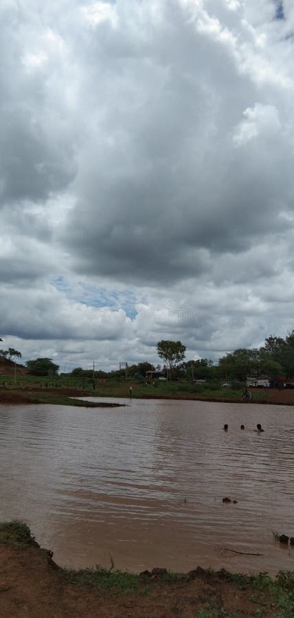 Pond in Side Swimming Boy Red Water and Rain Clouds Stock Photo - Image ...