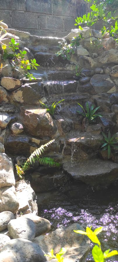 A Pond with Stone Steps As an Artificial Waterfall Stock Photo - Image ...