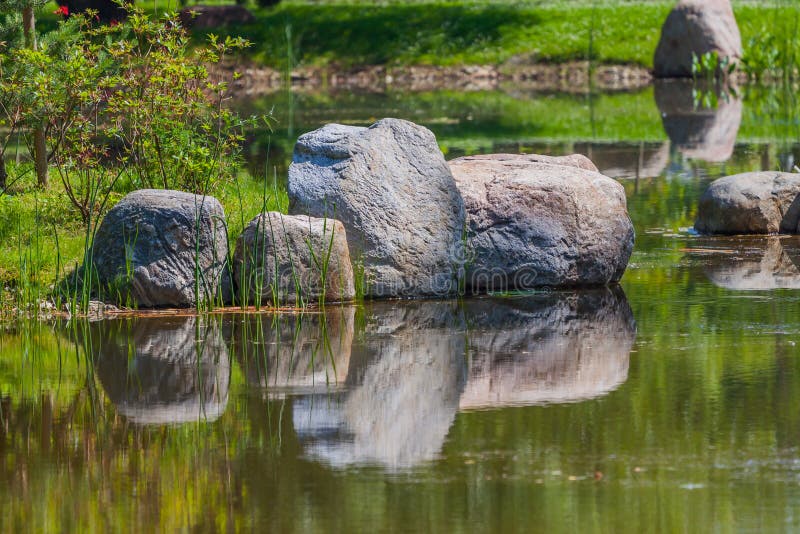 Pond with Stones Reflection Stock Image - Image of spring, travel: 31993545