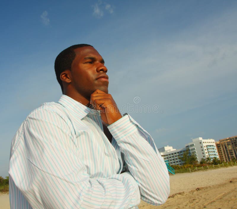 Black Male Model Pondering while Sitting is Chair Wearing a Suit Stock ...