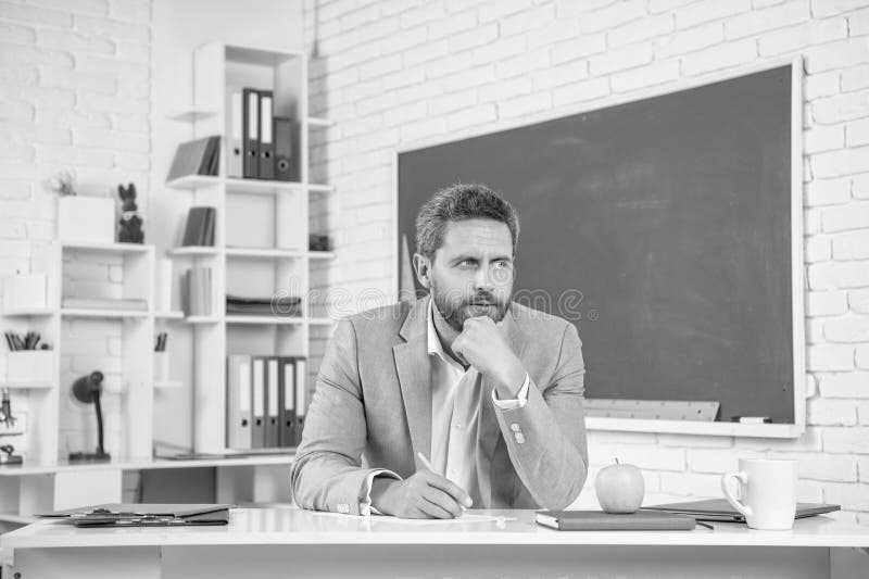Pondering School Tutor in Classroom at Blackboard Stock Photo - Image ...