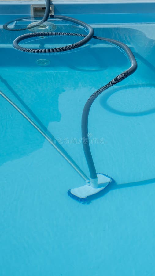 A Pool Cleaning Hose and Vacuum Head Positioned in a Nearly Empty Pool ...