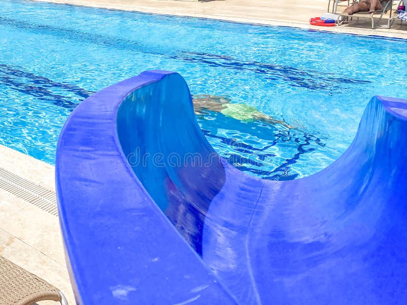 Pool with Clear Water and Multi-colored Water Slides in Indoor Aquapark ...