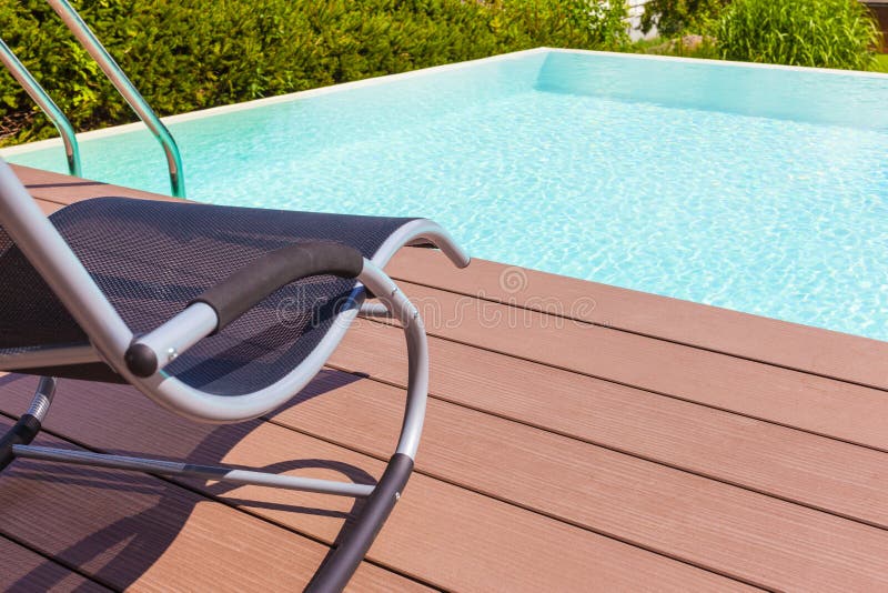 Pool deck chair stock photo. Image of exotic, sunbathing - 60696178