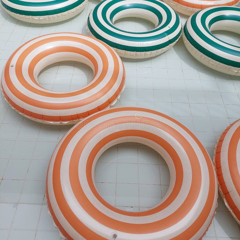Pool Decoration Using Inflatable Floats with Striped Designs Stock ...