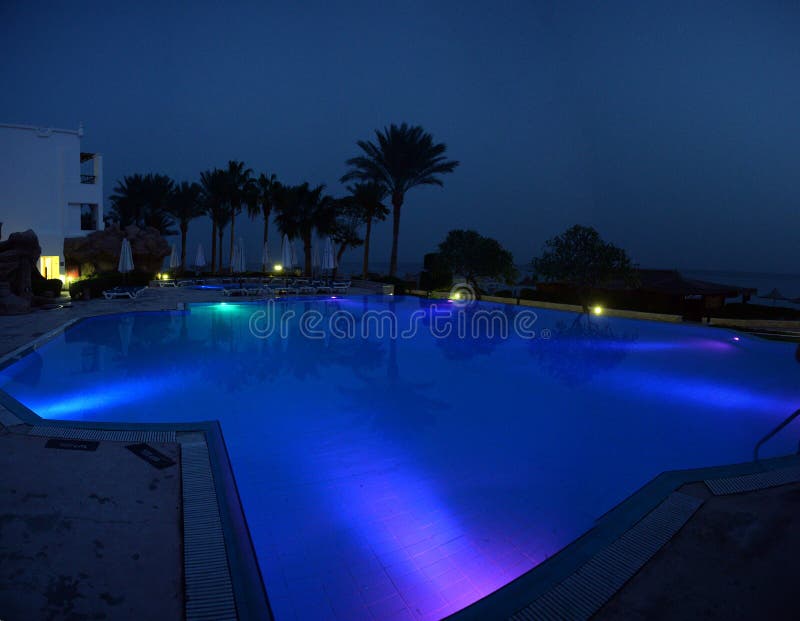 Pool illuminated at night stock image. Image of swimming - 68744867