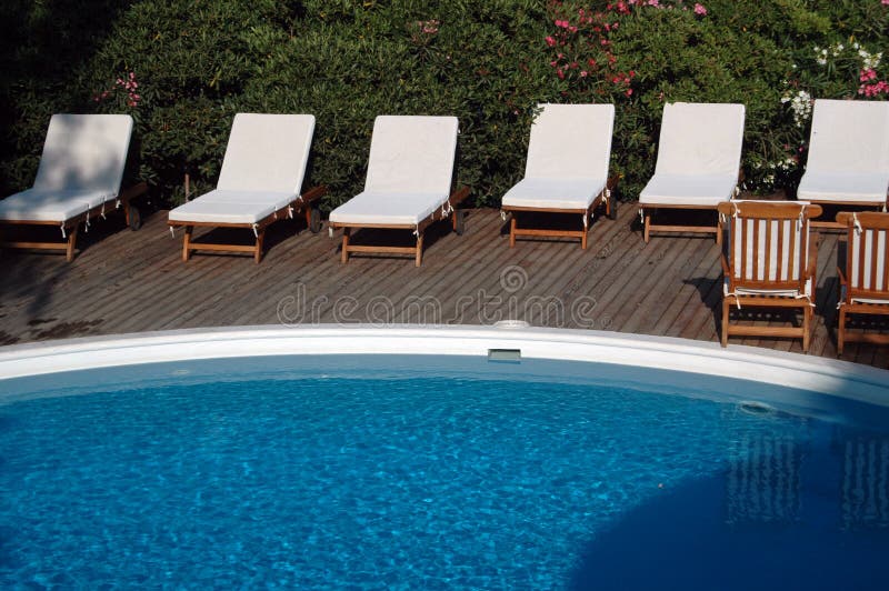 Deck Chairs at Resort Pool stock image. Image of relax - 309033