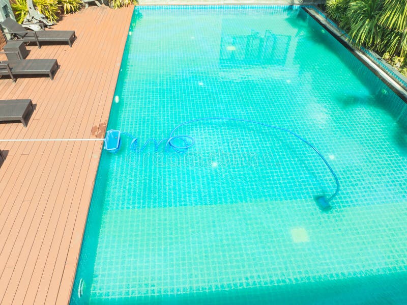 Pool Maintenance with Scoop Net and Automatic Robot Cleaner Stock Photo ...