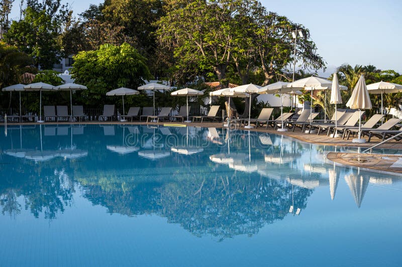 A Pool with Many Umbrellas and Lounge Chairs. Stock Photo - Image of ...