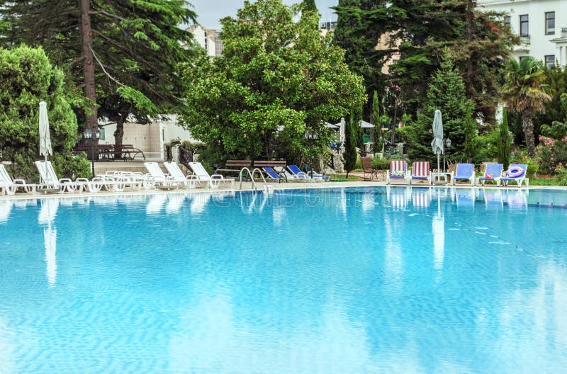 Pool near hotel stock image. Image of chair, nature, landscape - 96398221