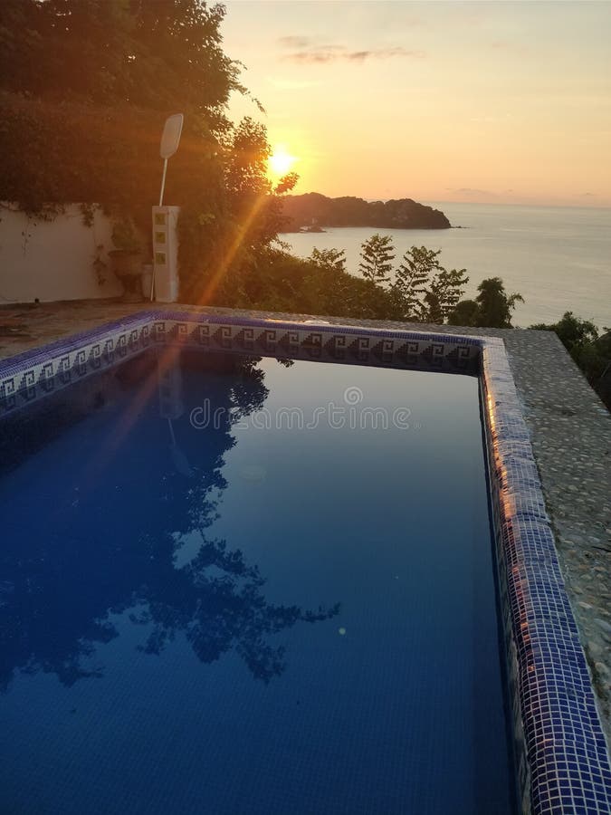 Pool and Ocean at Sunset Flare Stock Image - Image of dawn, ocean ...