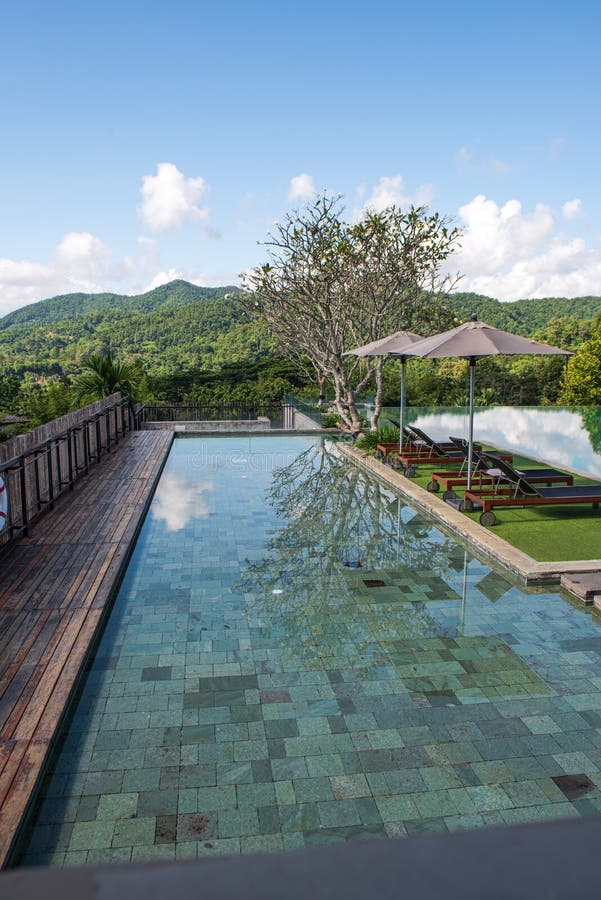 Pool Side Atmosphere with Relaxing Chairs Placed Around the Pool. Stock ...