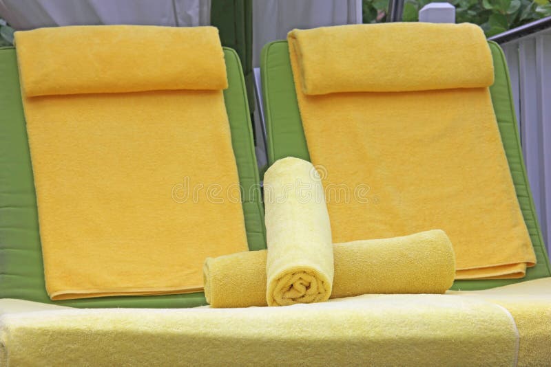 Pool Side Lounge Chairs with Yellow Towels Stock Image - Image of ...