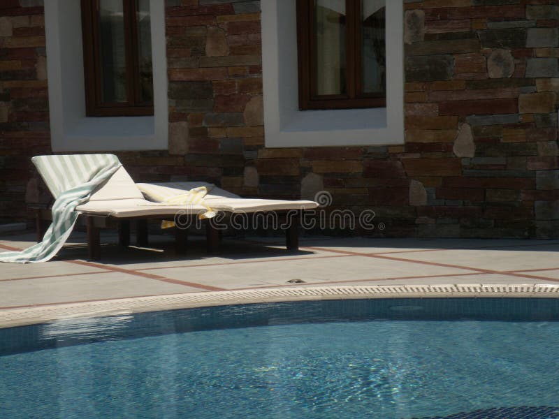 Pool sunbeds stock image. Image of motels, greek, chairs - 899813