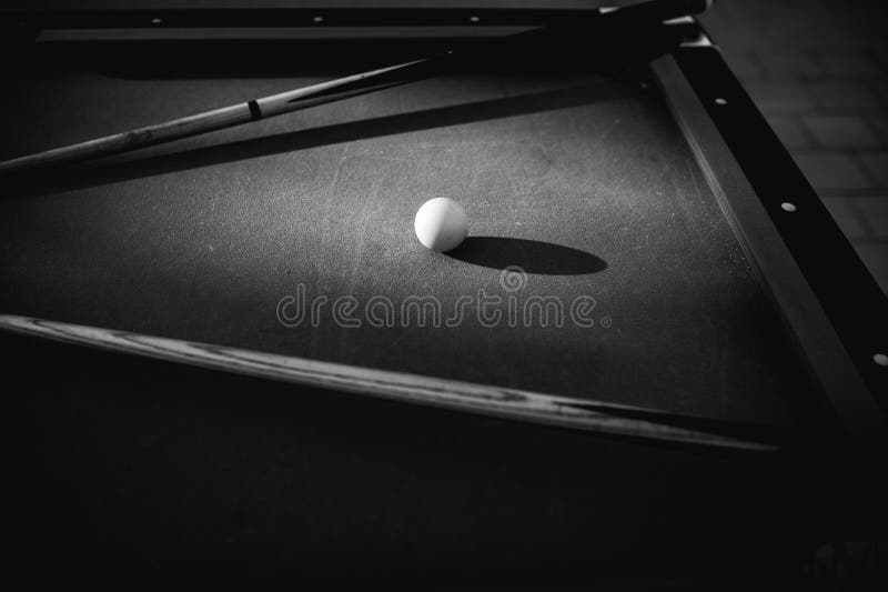 A Pool Table with Scattered Billiard Balls, a Cue Stick Stock Photo ...