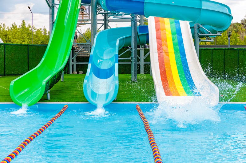A Pool with a Green, Blue and Rainbow Colored Slide Stock Image - Image ...