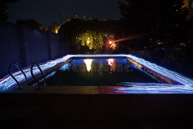 Pool and Waterfall at Night - Vacation Background. Colorful Light ...