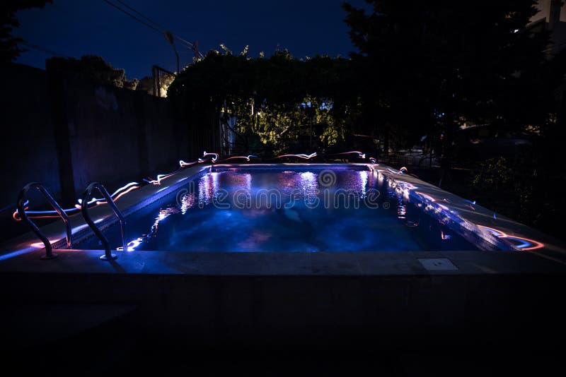 Pool and Waterfall at Night - Vacation Background. Colorful Light ...