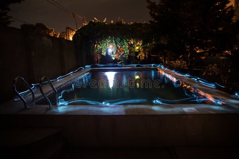 Pool and Waterfall at Night - Vacation Background. Colorful Light ...