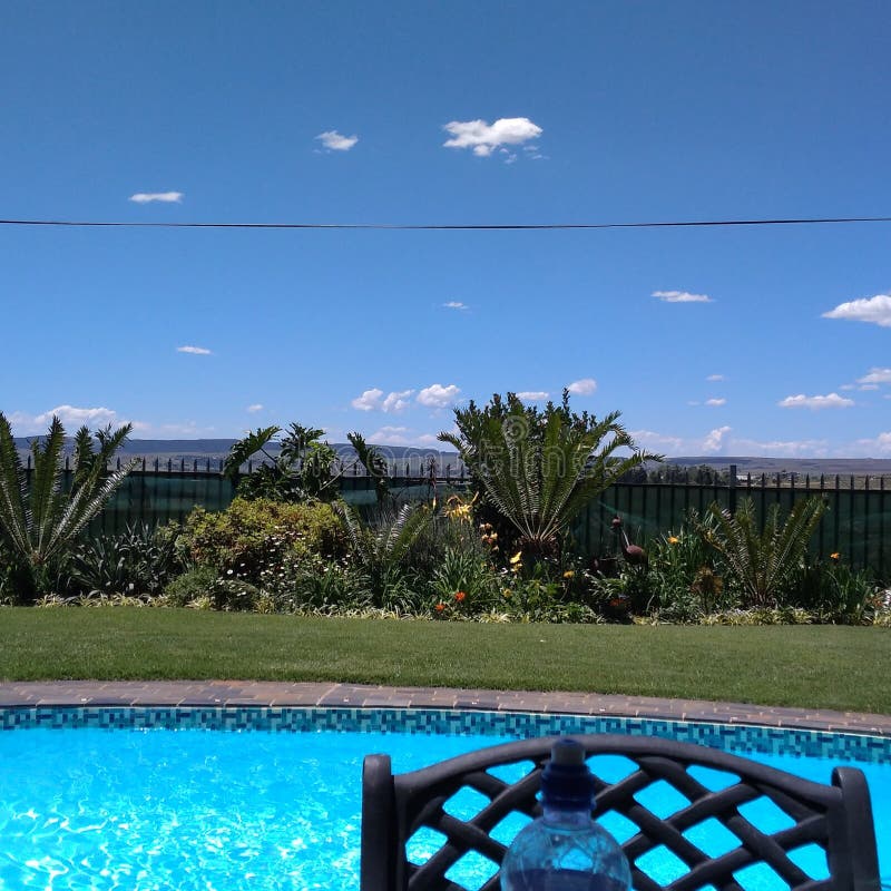 Poolside stock image. Image of garden, chilling, blue - 105179549