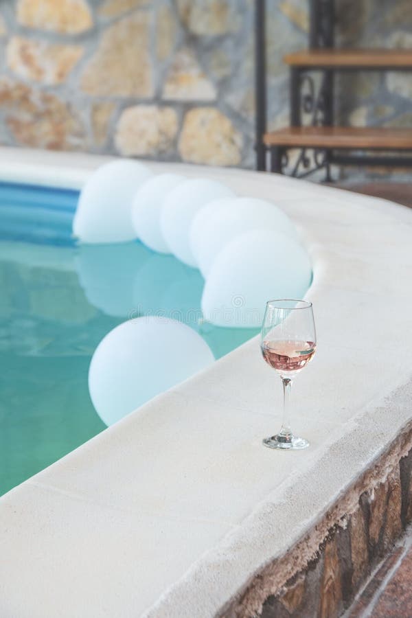 Poolside Party Scene with Balloons and a Glass of Rose Wine Stock Image ...