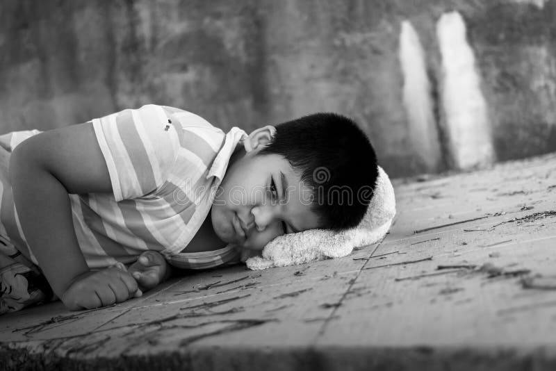Poor Boy Sad Lying on the Dirty Floor Stock Image - Image of poor ...