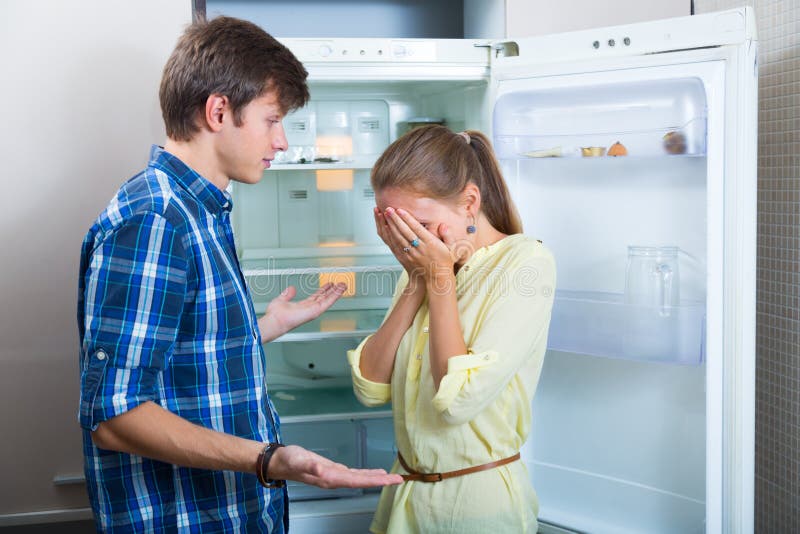 Poor Couple Near Empty Fridge Stock Photo - Image of appliance ...