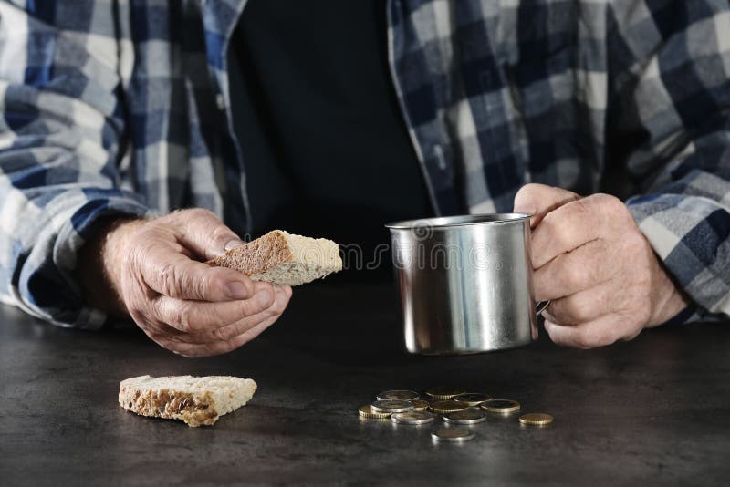 Poor Elderly Man with Piece of Bread and Metal Mug at Table Stock Photo ...