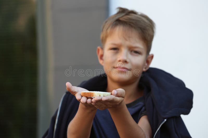Poor little boy with bread stock image. Image of outdoors - 130499831