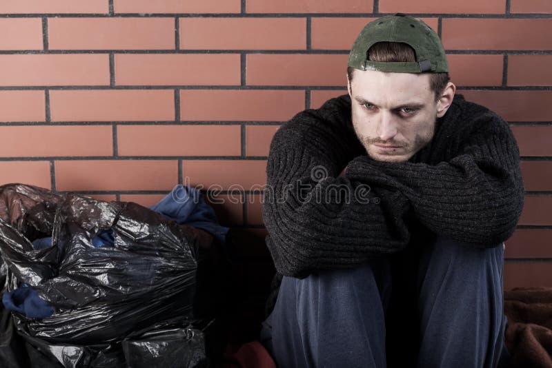 Poor Man Sitting Hunched on the Ground Stock Image - Image of ...