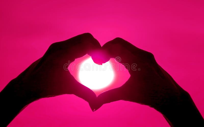 Silhouette of Hand Making Heart Sign To the Bright Sun Stock Image ...