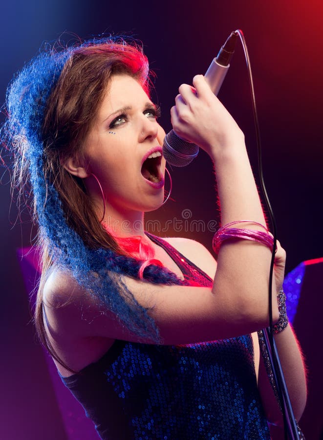 Pop star singing on stage stock image. Image of event - 39196579