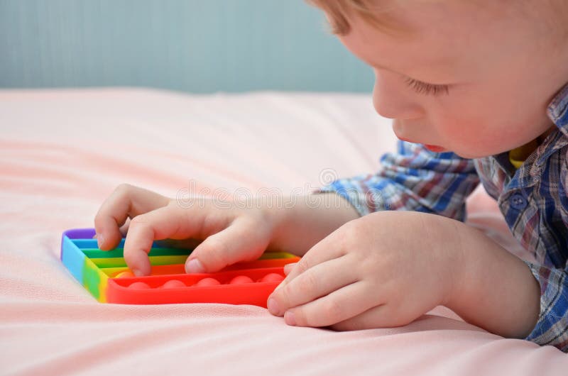 POP it Toy. the Boy is Playing with a Toy Stock Photo - Image of ...