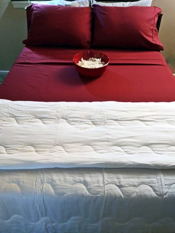 Popcorn on bed stock photo. Image of flooring, clothing - 184659010