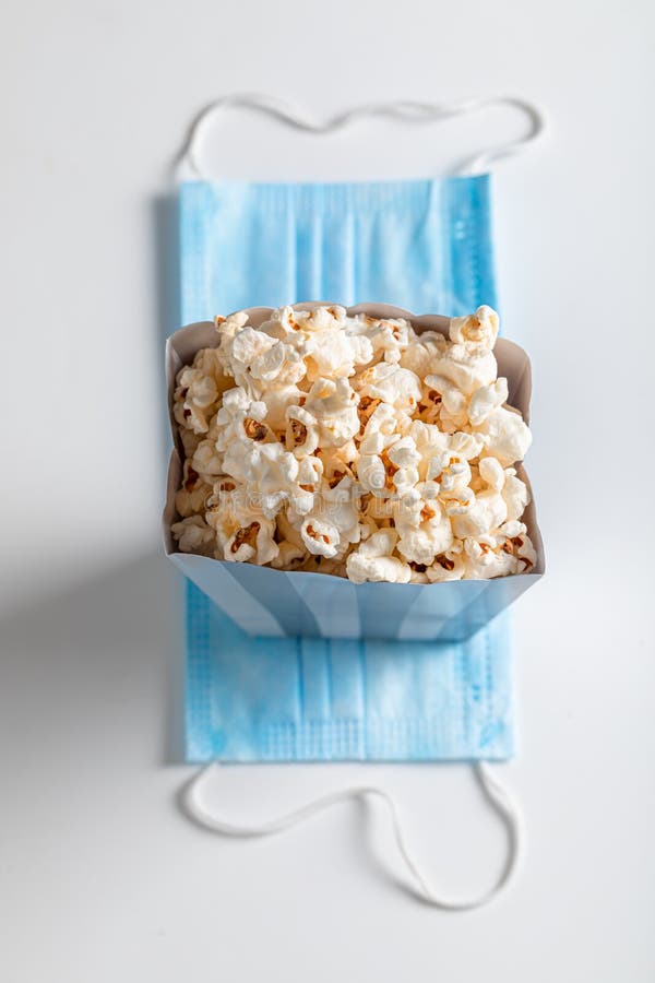 Popcorn Box and Mask. Concept of Coronavirus and Protective Stock Photo ...